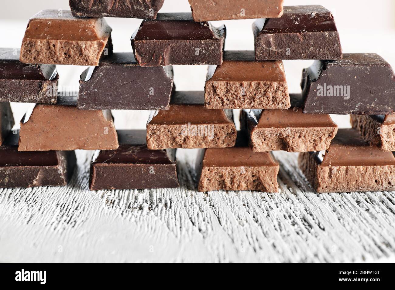 Pyramid of squared chocolate on wooden table Stock Photo - Alamy