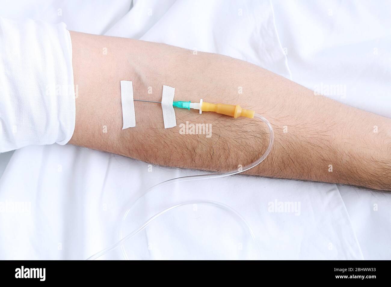 Man hand with dropper needle on bed close-up Stock Photo - Alamy