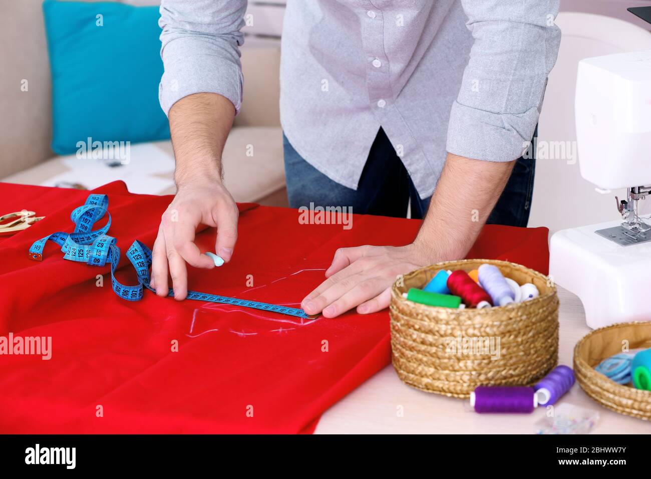 Male dressmaker tailor fabric on table Stock Photo - Alamy
