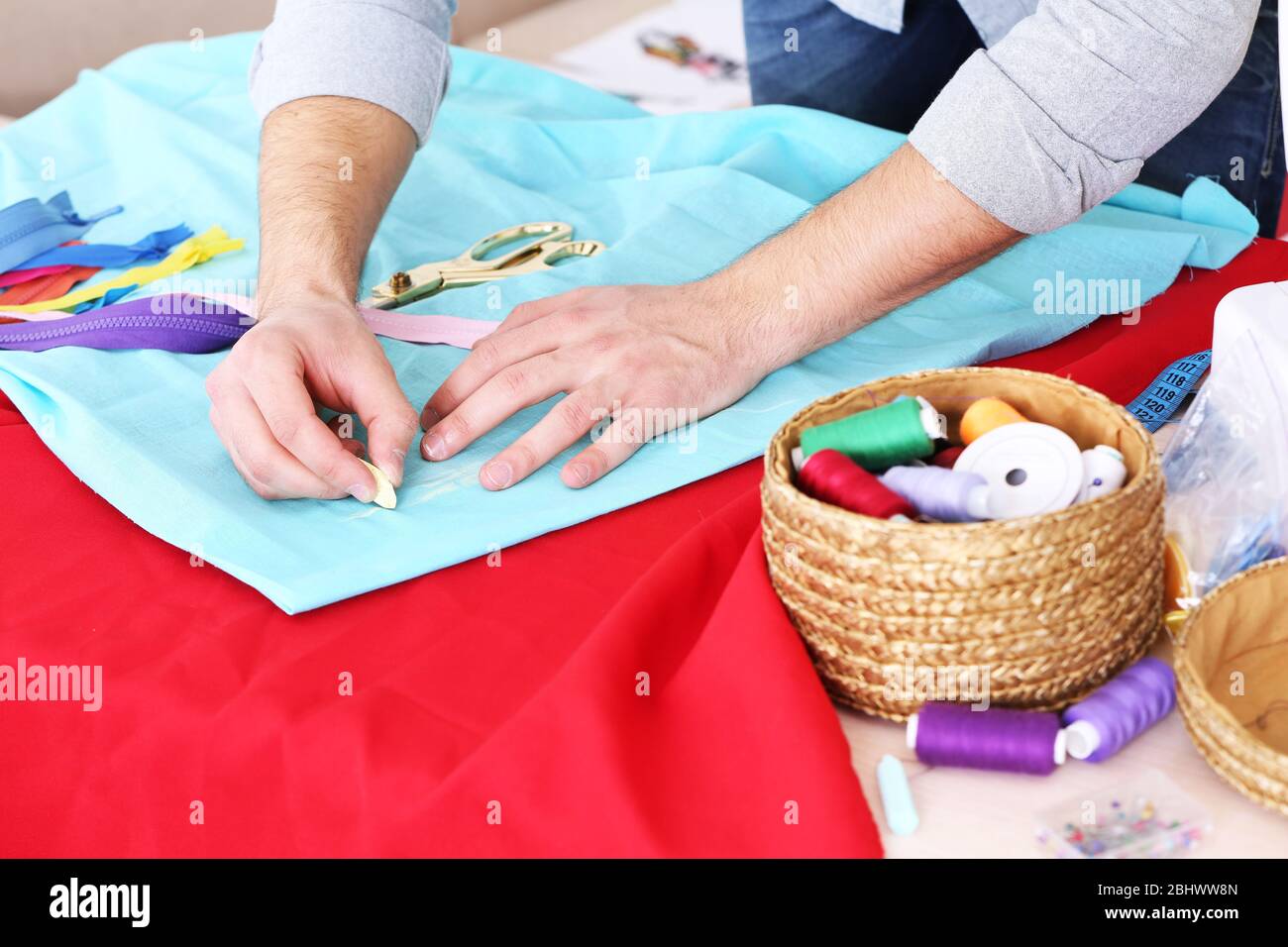 Male dressmaker tailor fabric on table Stock Photo - Alamy