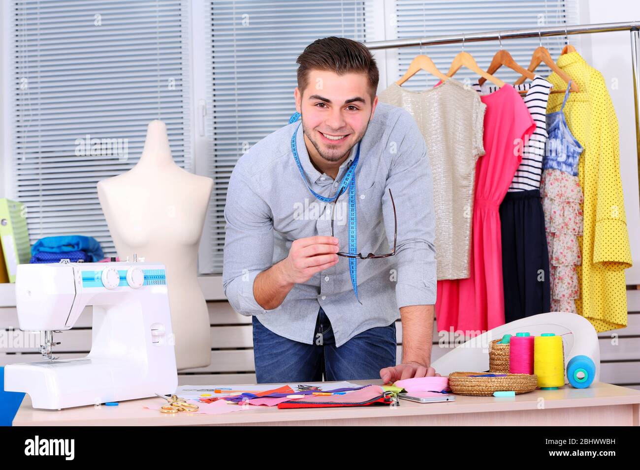 Young man fashion designer creates new collection of clothes Stock ...