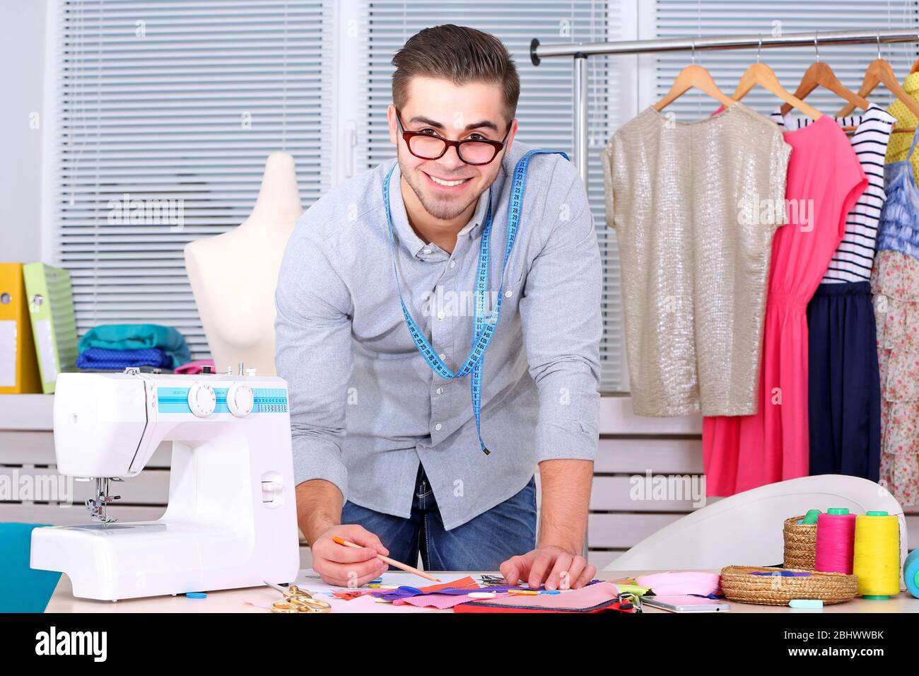 Young man fashion designer creates new collection of clothes Stock ...