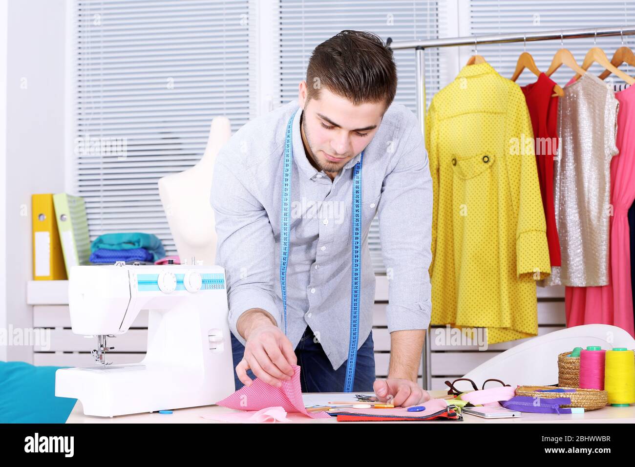 Young man fashion designer creates new collection of clothes Stock ...
