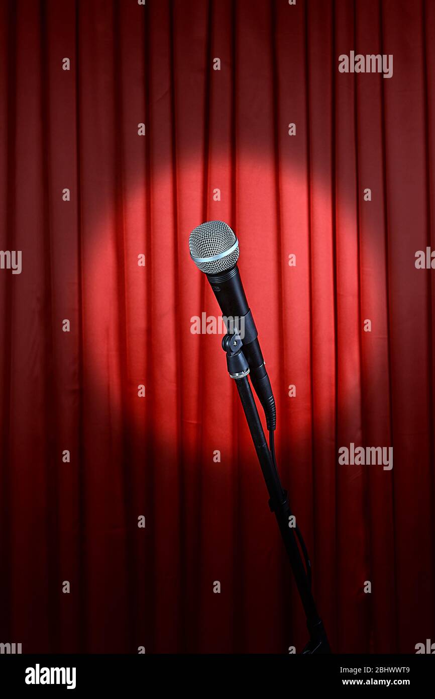 Microphone on stand on red curtain background Stock Photo - Alamy