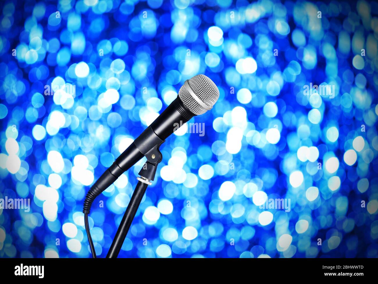 Microphone on stand on blue background Stock Photo - Alamy