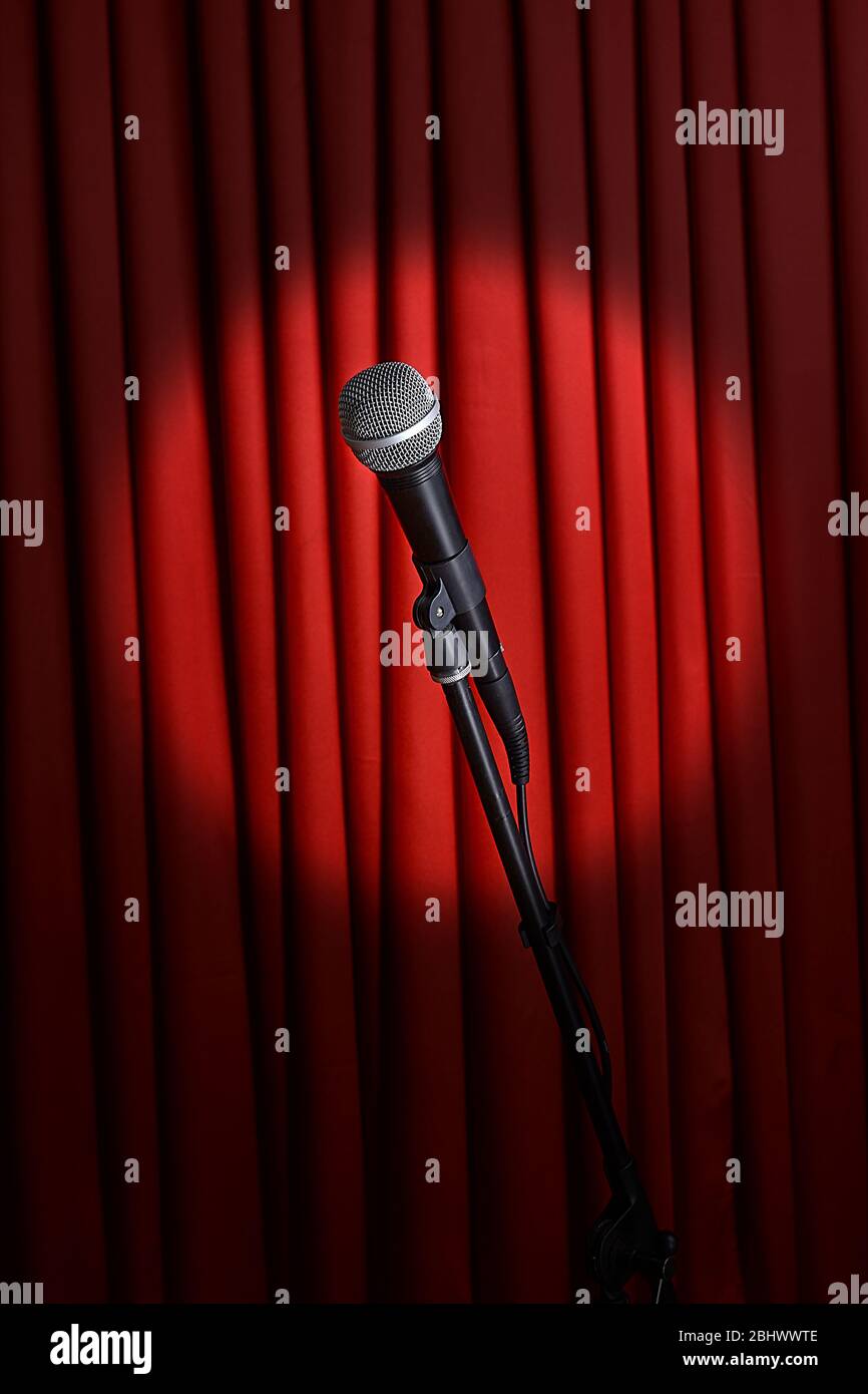 Microphone on stand on red curtain background Stock Photo - Alamy