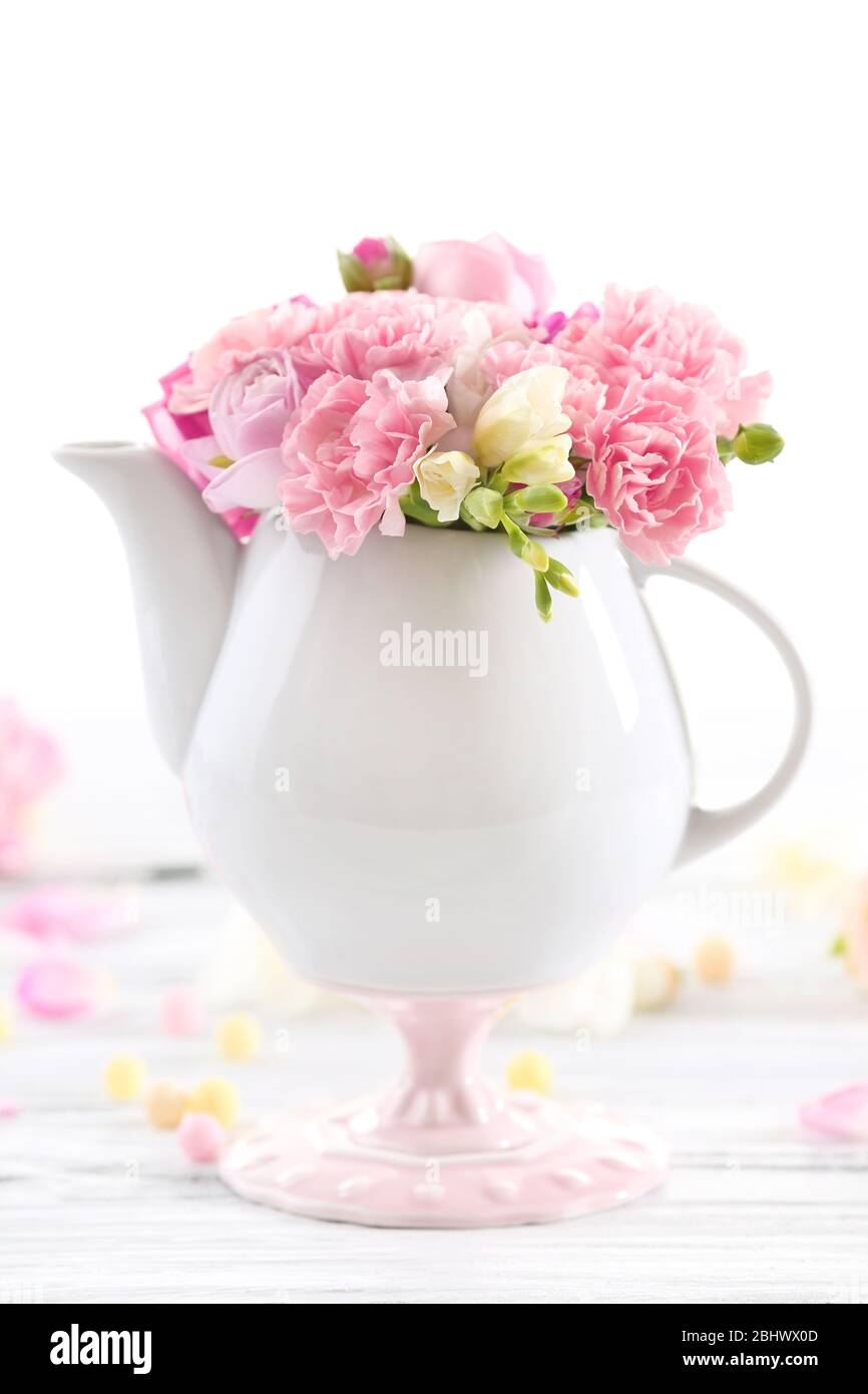Beautiful spring flowers in teapot isolated on white Stock Photo - Alamy