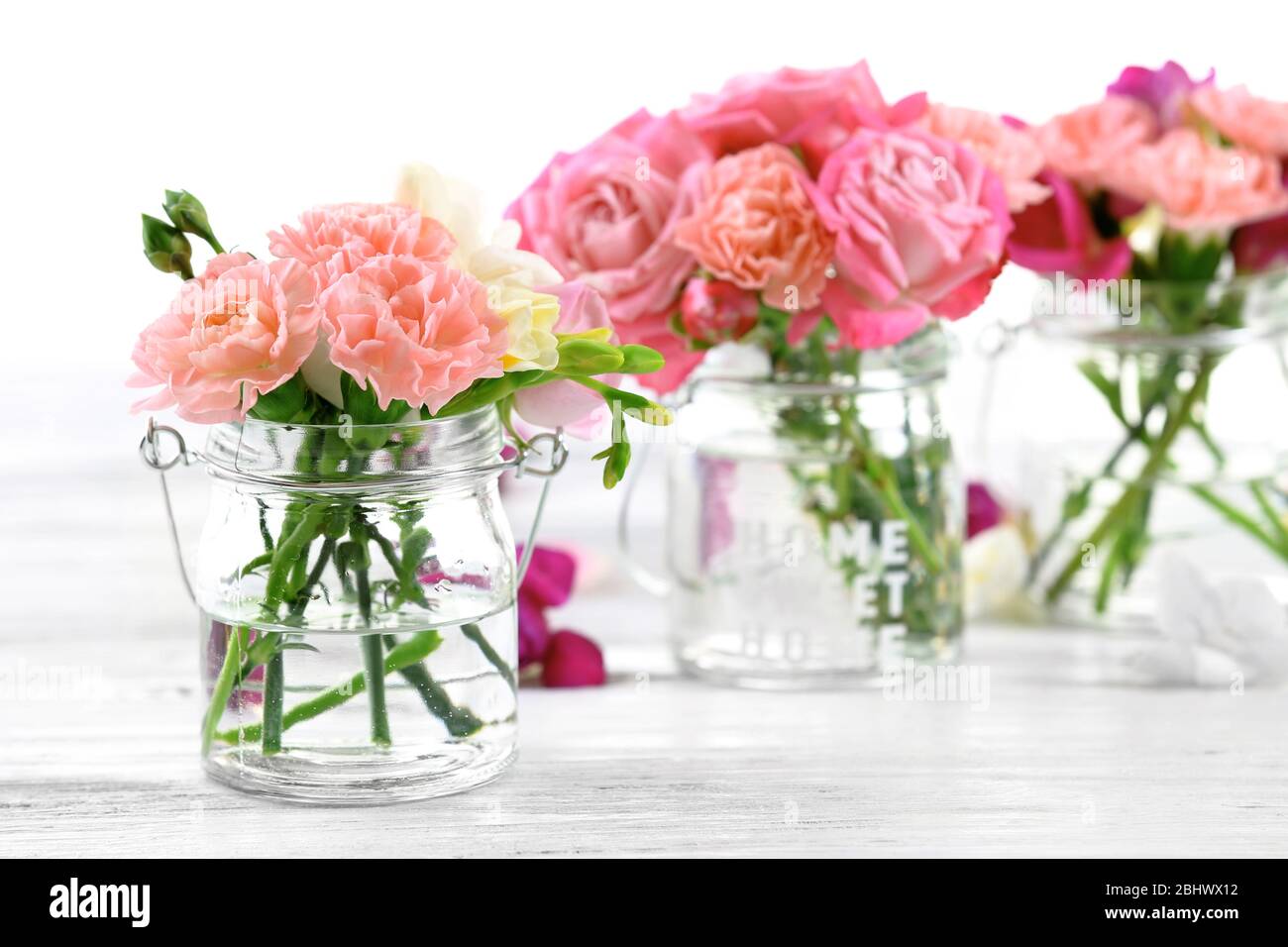 Beautiful spring flowers in glass bottles Stock Photo - Alamy