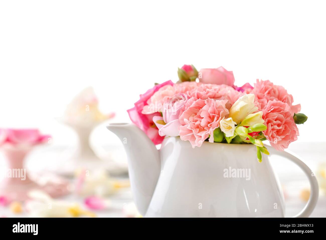 Beautiful spring flowers in teapot isolated on white Stock Photo - Alamy