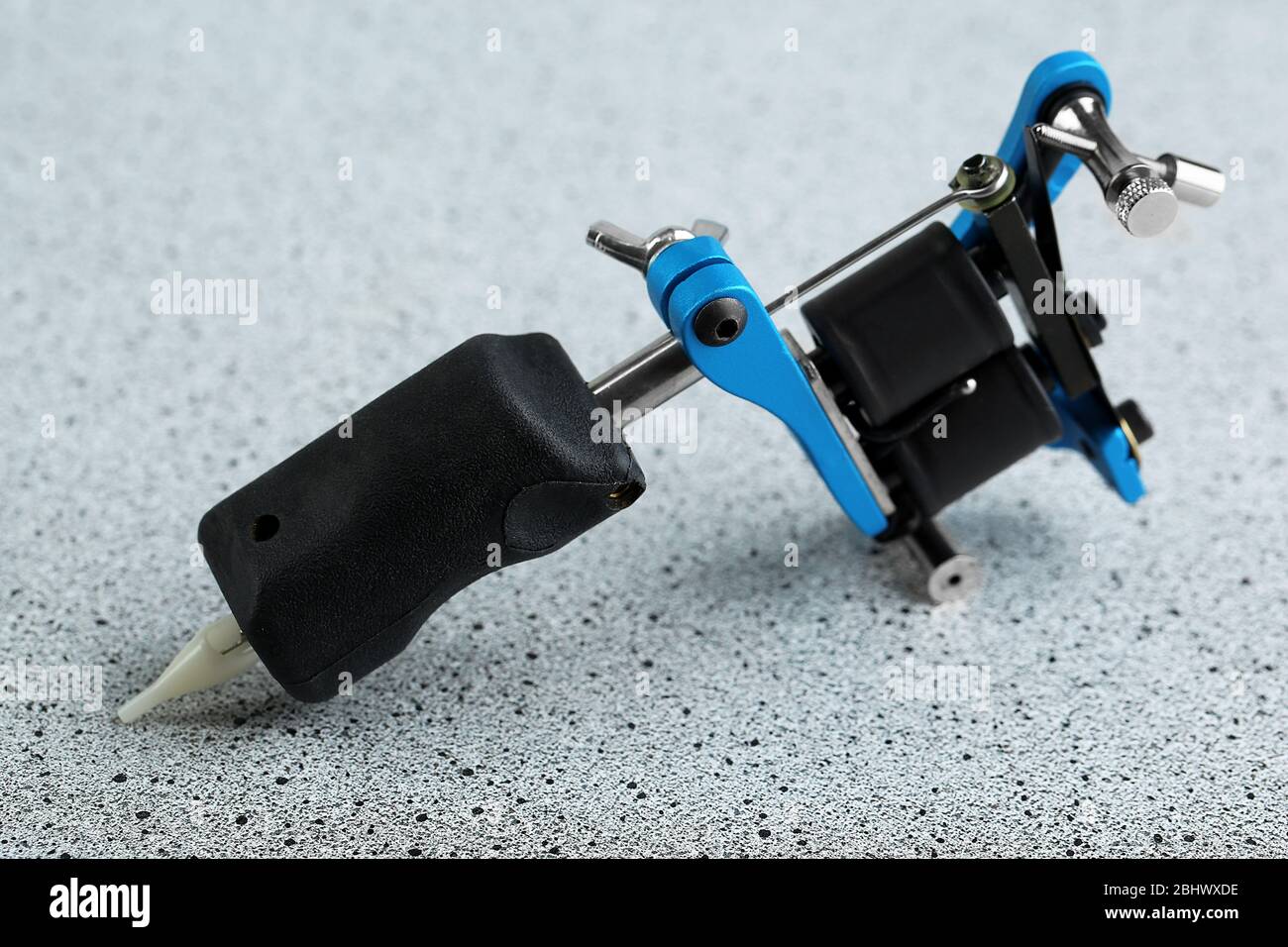 Machine for tattoo, on grey background Stock Photo - Alamy