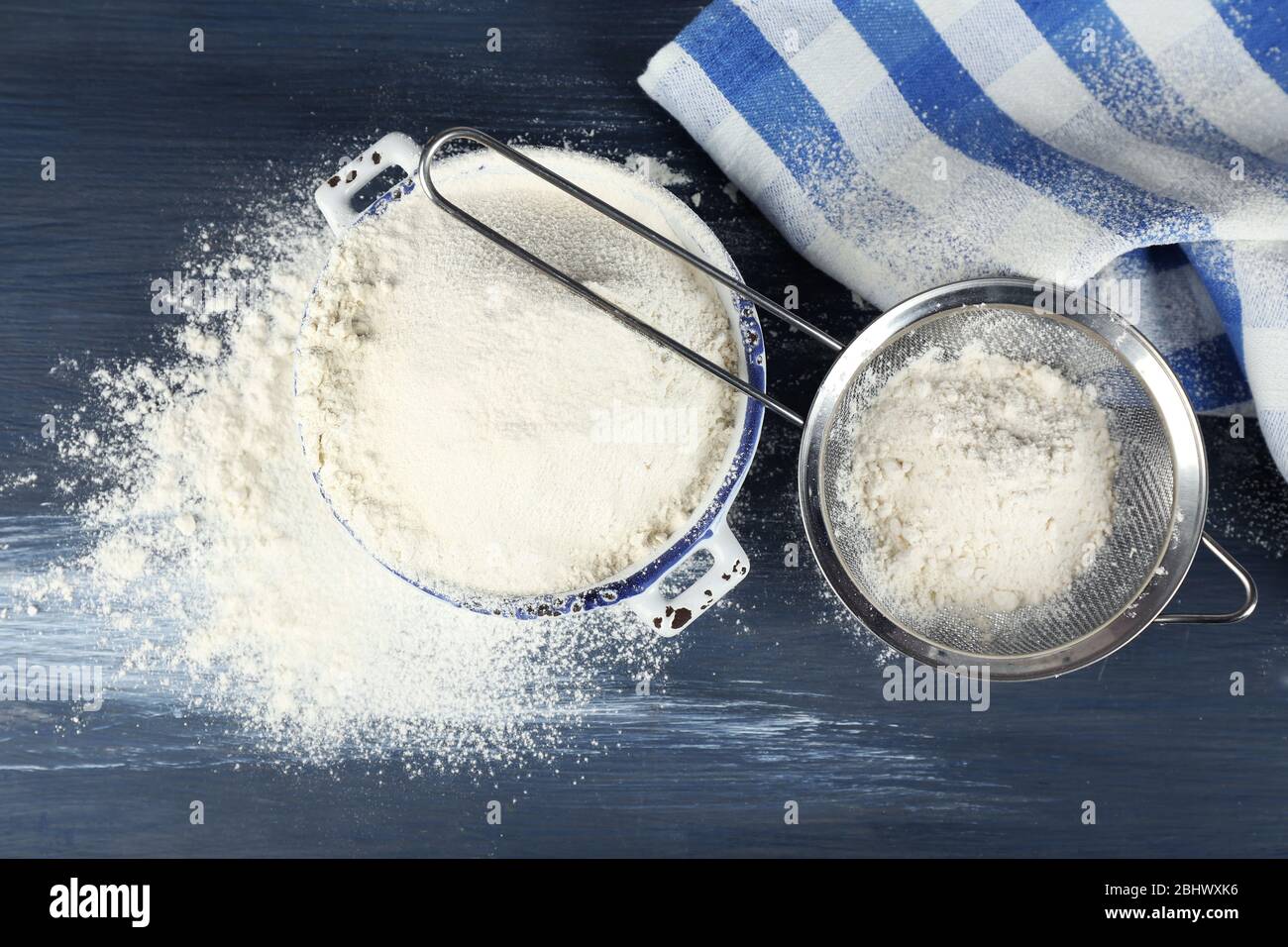 Sifting flour through sieve on wooden table, top view Stock Photo - Alamy