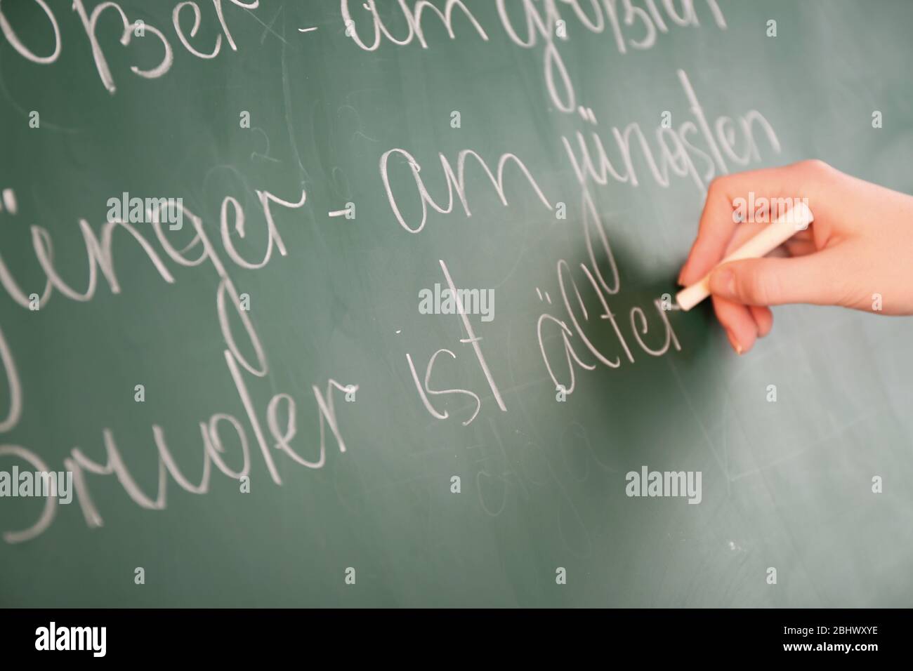 Teacher hand writing grammar sentences on blackboard background Stock ...