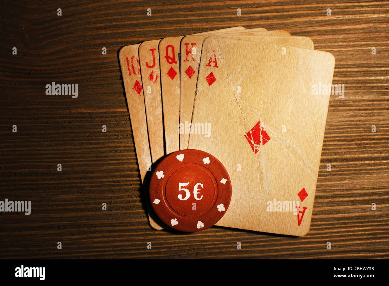 Playing cards with chips on wooden background Stock Photo - Alamy