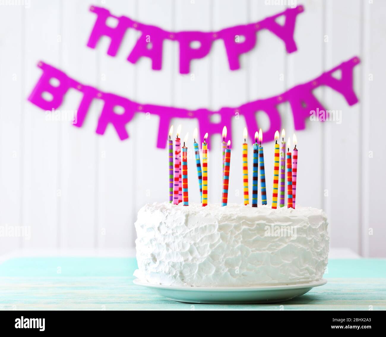 Birthday cake with candles on colorful background Stock Photo - Alamy
