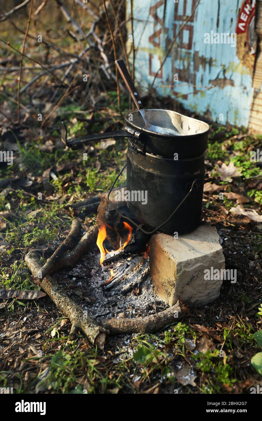 Metal bucket on fire, outdoors Stock Photo - Alamy