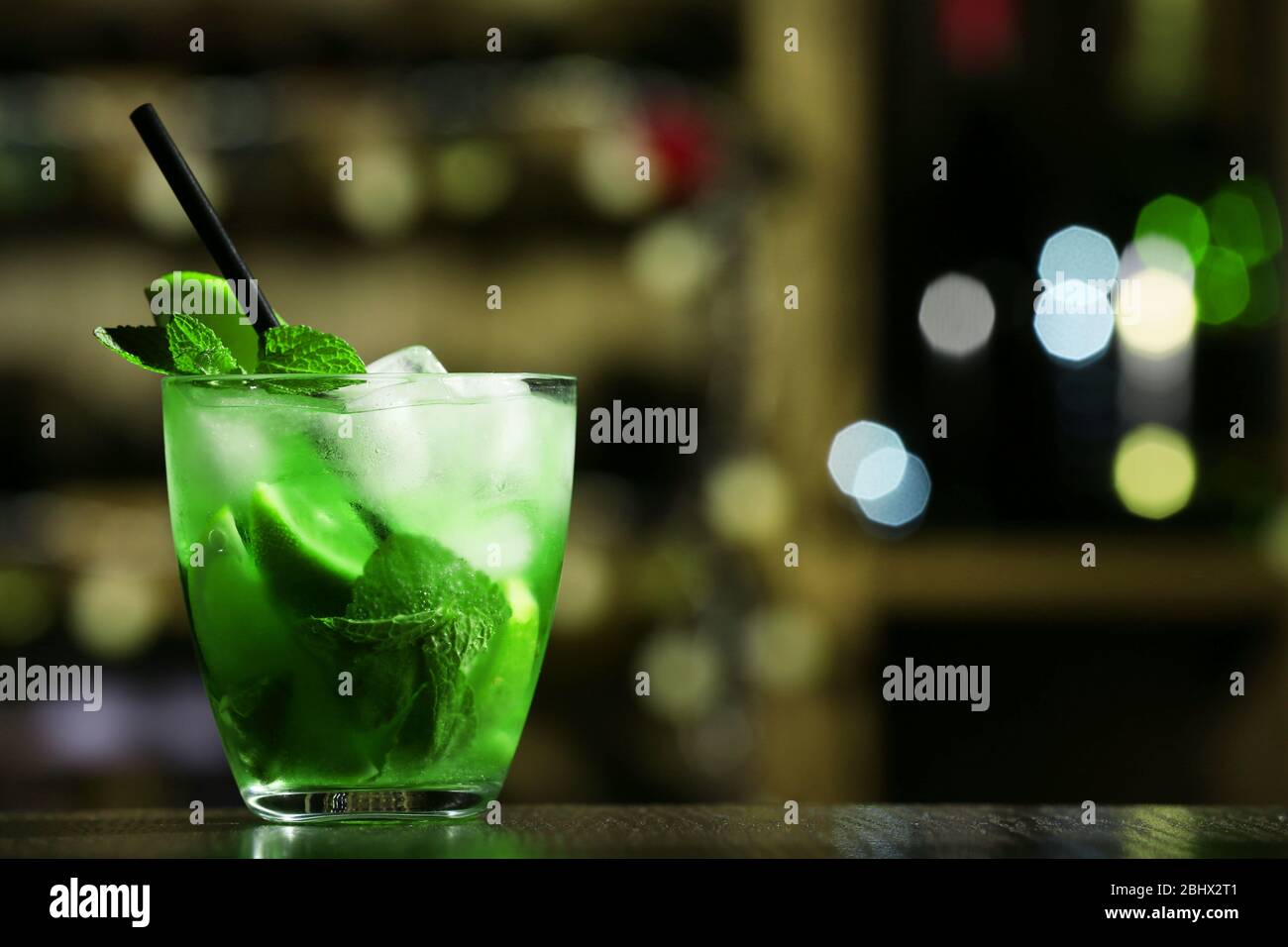 Glass of cocktail on bar background Stock Photo - Alamy