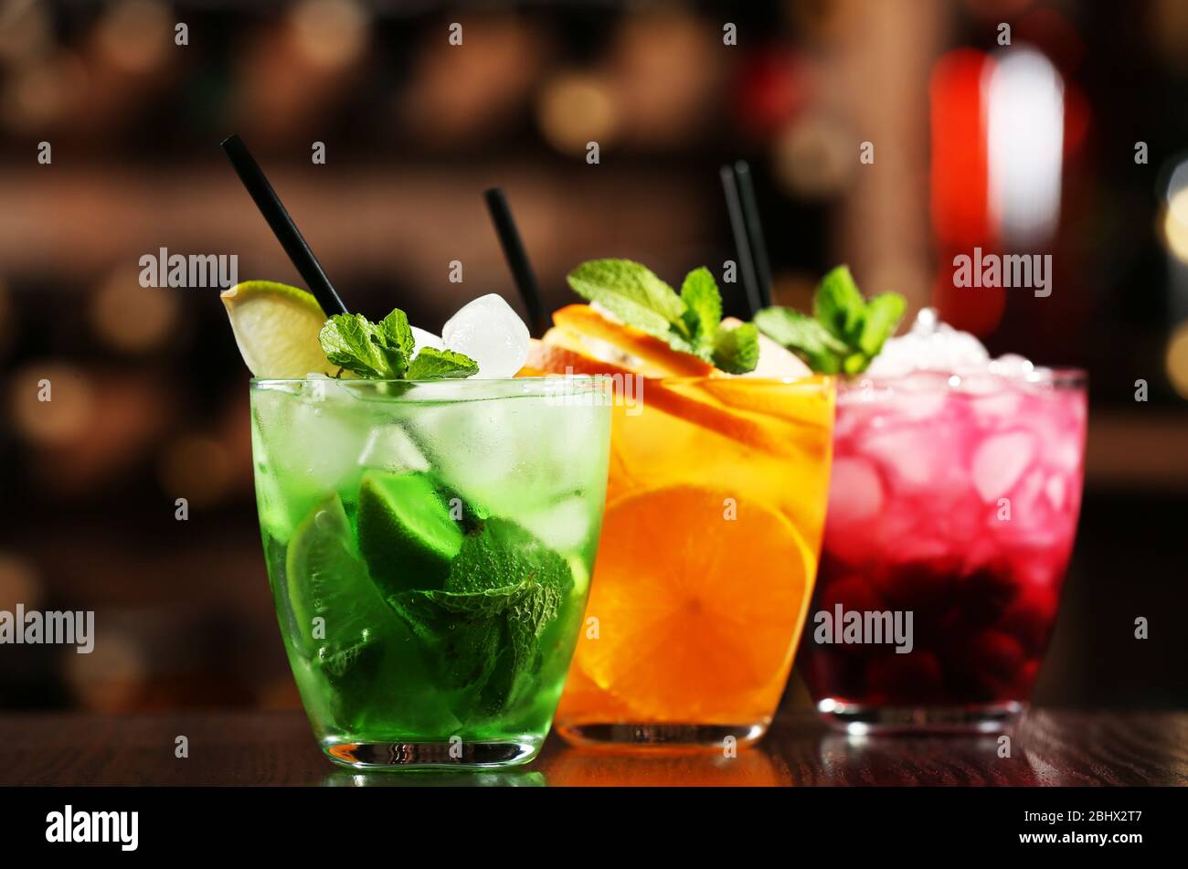 Glasses of cocktails on bar background Stock Photo - Alamy