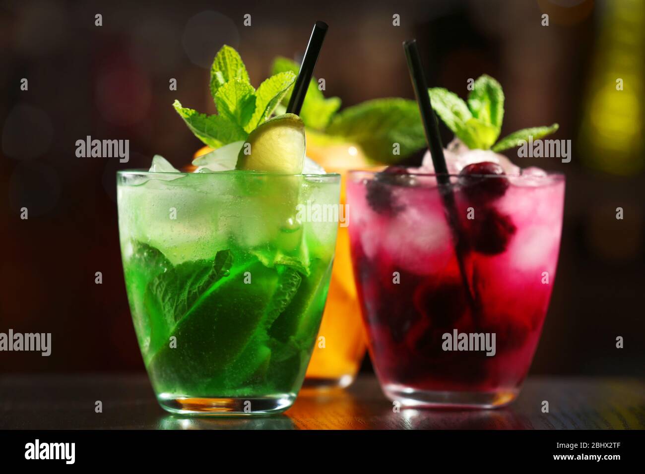 Glasses of cocktails on bar background Stock Photo - Alamy