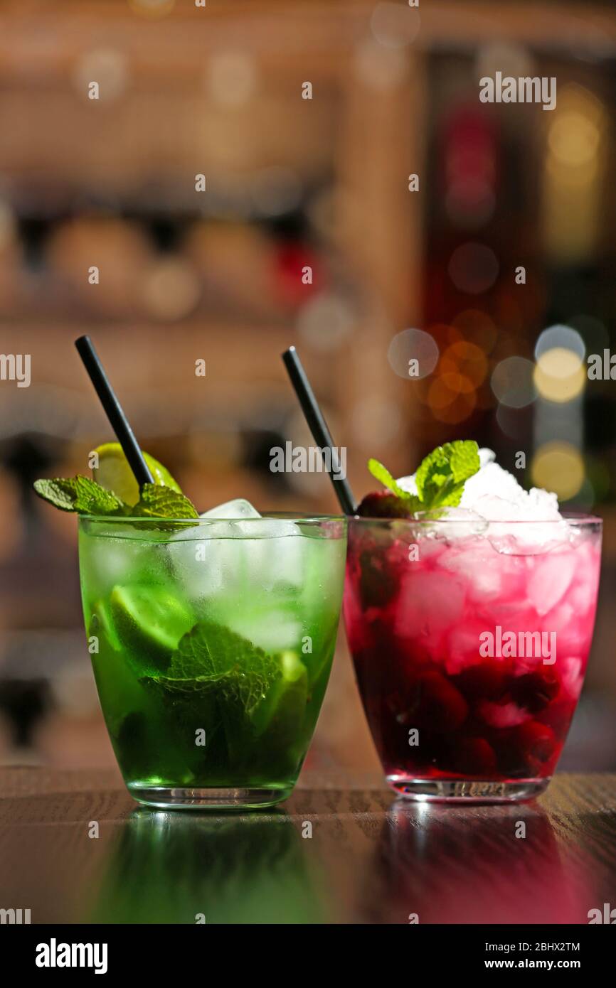 Glasses of cocktails on bar background Stock Photo - Alamy