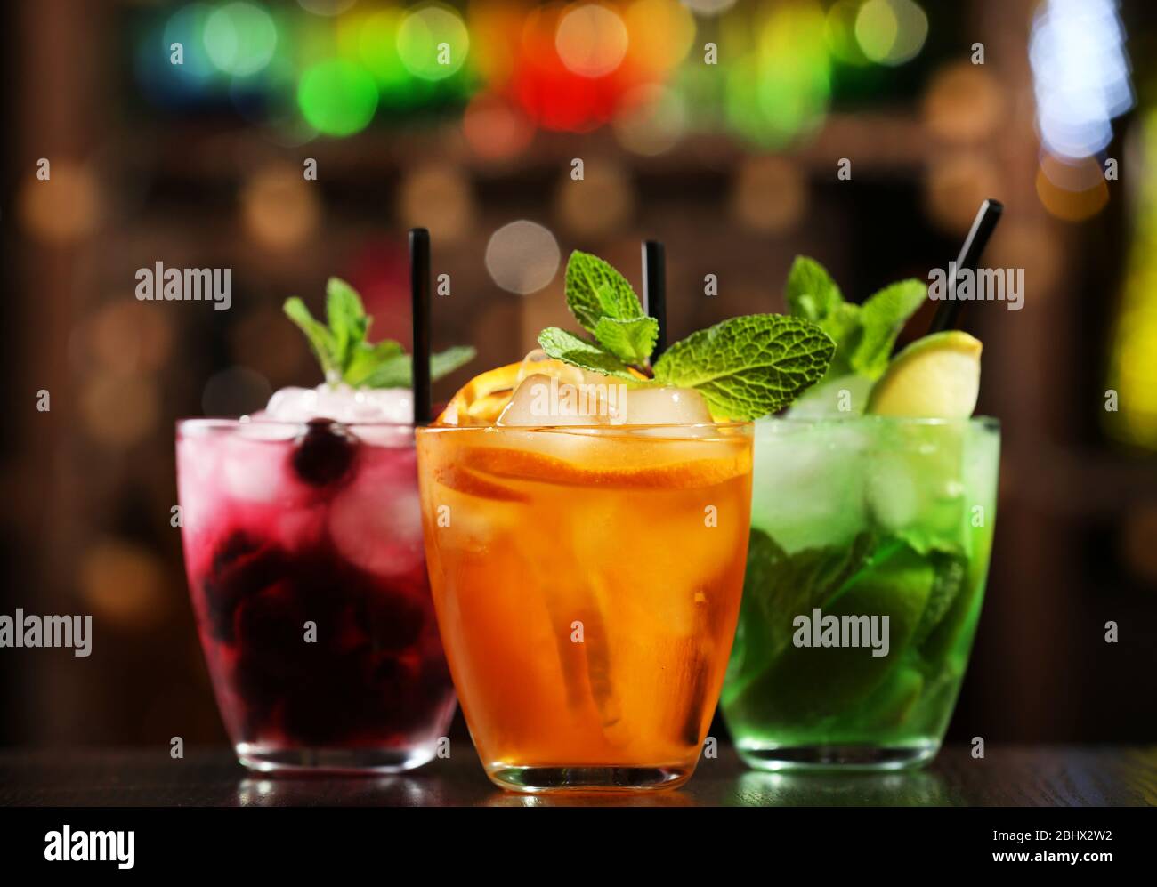 Glasses of cocktails on bar background Stock Photo - Alamy