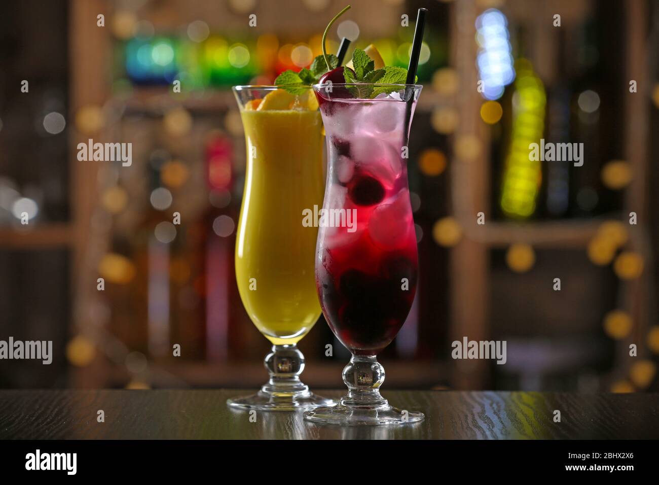 Glasses of cocktails on bar background Stock Photo - Alamy