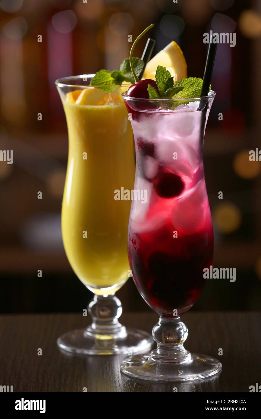 Glasses of cocktails on bar background Stock Photo - Alamy