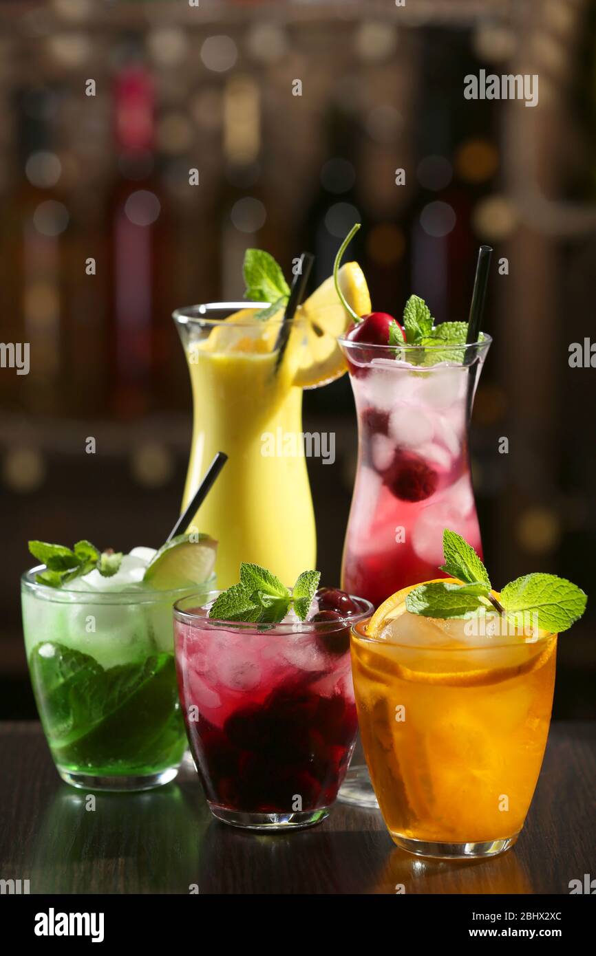 Glasses of cocktails on bar background Stock Photo - Alamy