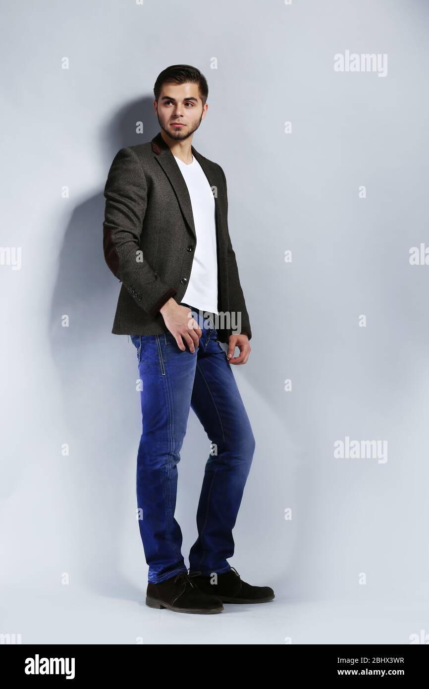 Young man on gray background Stock Photo - Alamy