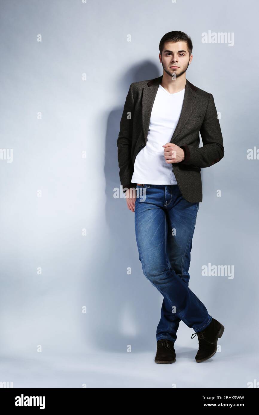 Young man on gray background Stock Photo - Alamy