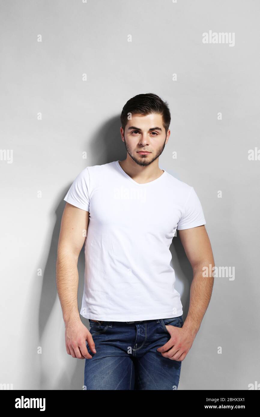 Young man on gray background Stock Photo - Alamy