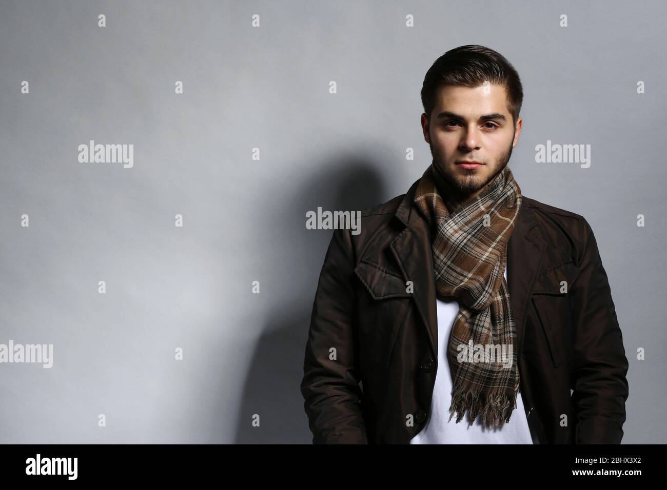 Portrait of young man on gray background Stock Photo - Alamy