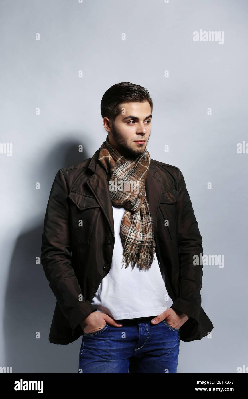 Portrait of young man on gray background Stock Photo - Alamy