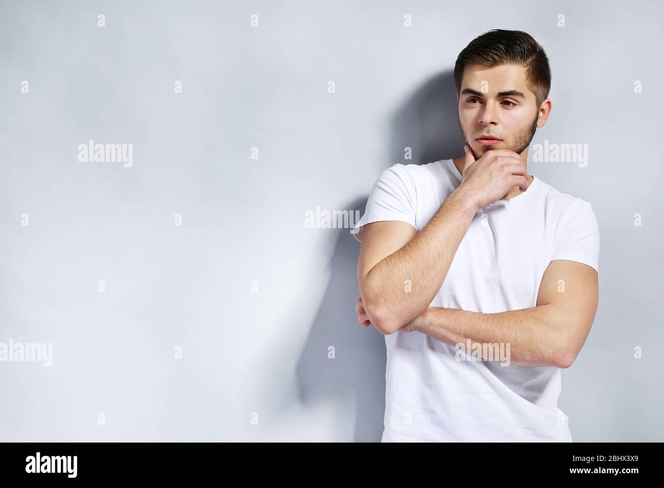 Young man on gray background Stock Photo - Alamy