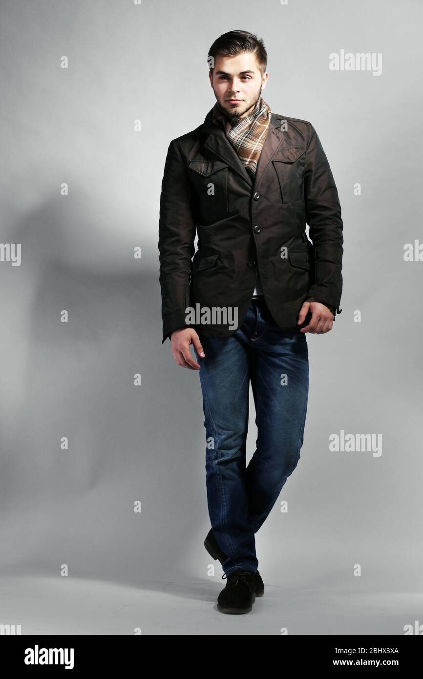 Portrait of young man on gray background Stock Photo - Alamy