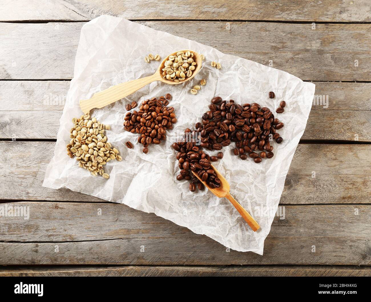 Coffee beans on crumpled parchment on wooden table, top view Stock ...