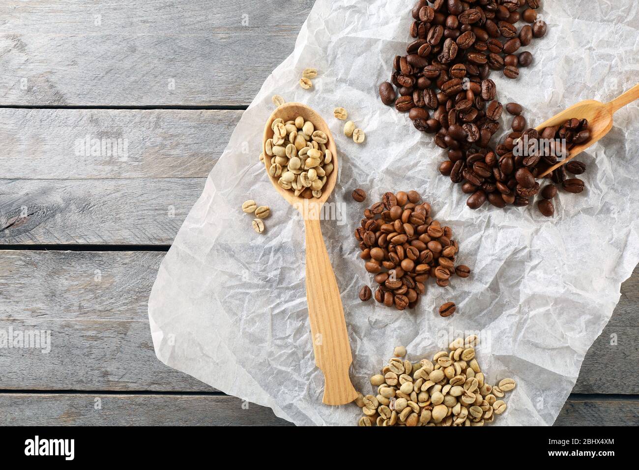 Coffee beans on crumpled parchment on wooden table, top view Stock ...