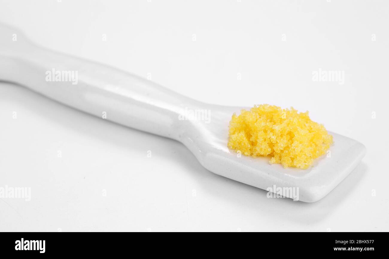 Laboratory spatula with granules isolated on white Stock Photo - Alamy