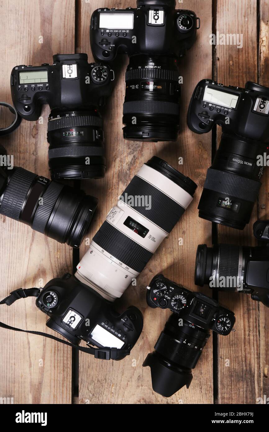 Modern cameras on wooden table, top view Stock Photo - Alamy