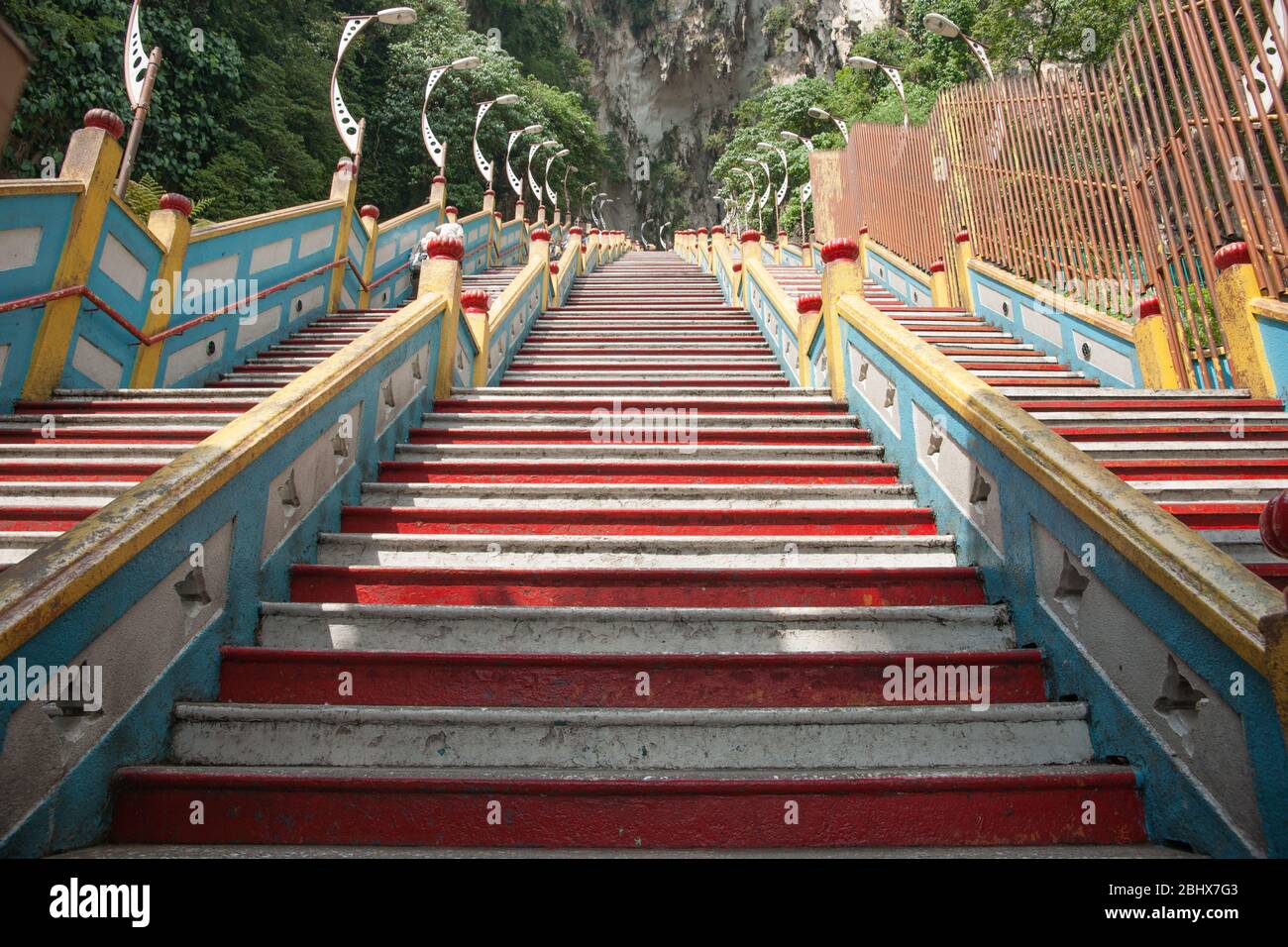 Steep yellow, blue and red step leading upward to sacred Batu Caves in ...