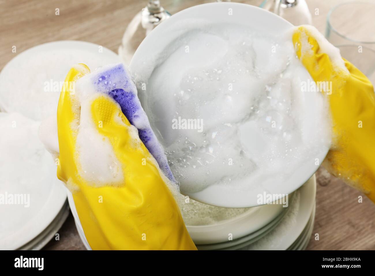 Female hand washing dish close up Stock Photo - Alamy