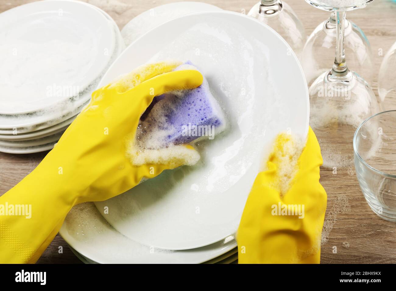 Female hand washing dish close up Stock Photo - Alamy