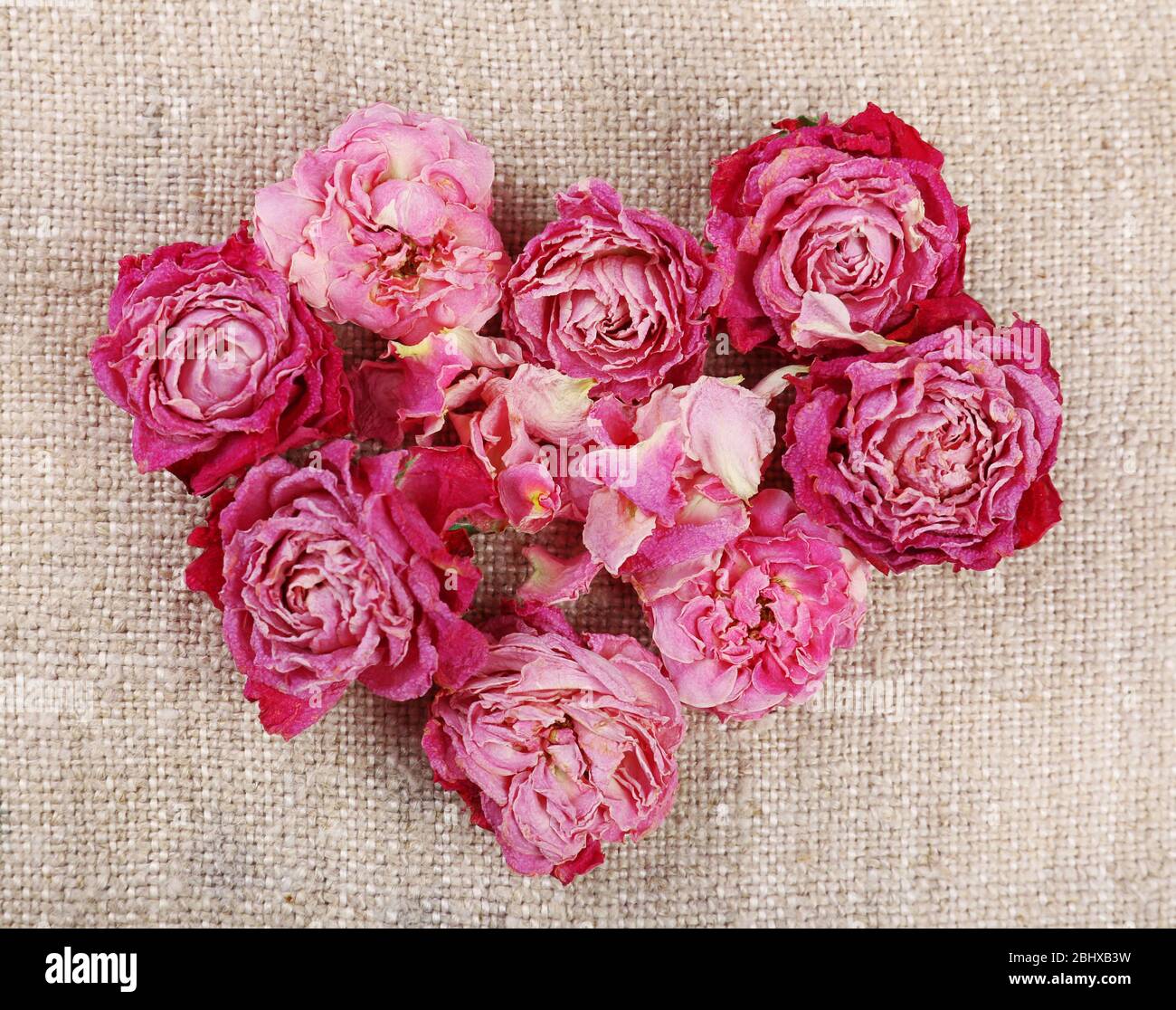 Heart of beautiful dry flowers on sackcloth background Stock Photo - Alamy