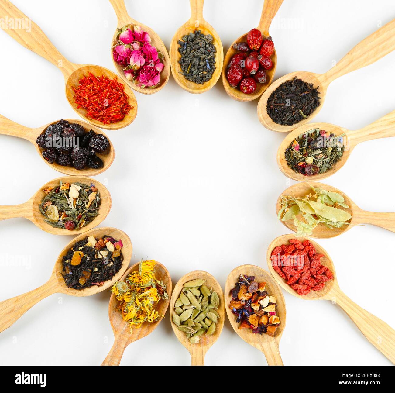 Collection of tea and natural additives in wooden spoons, isolated on ...