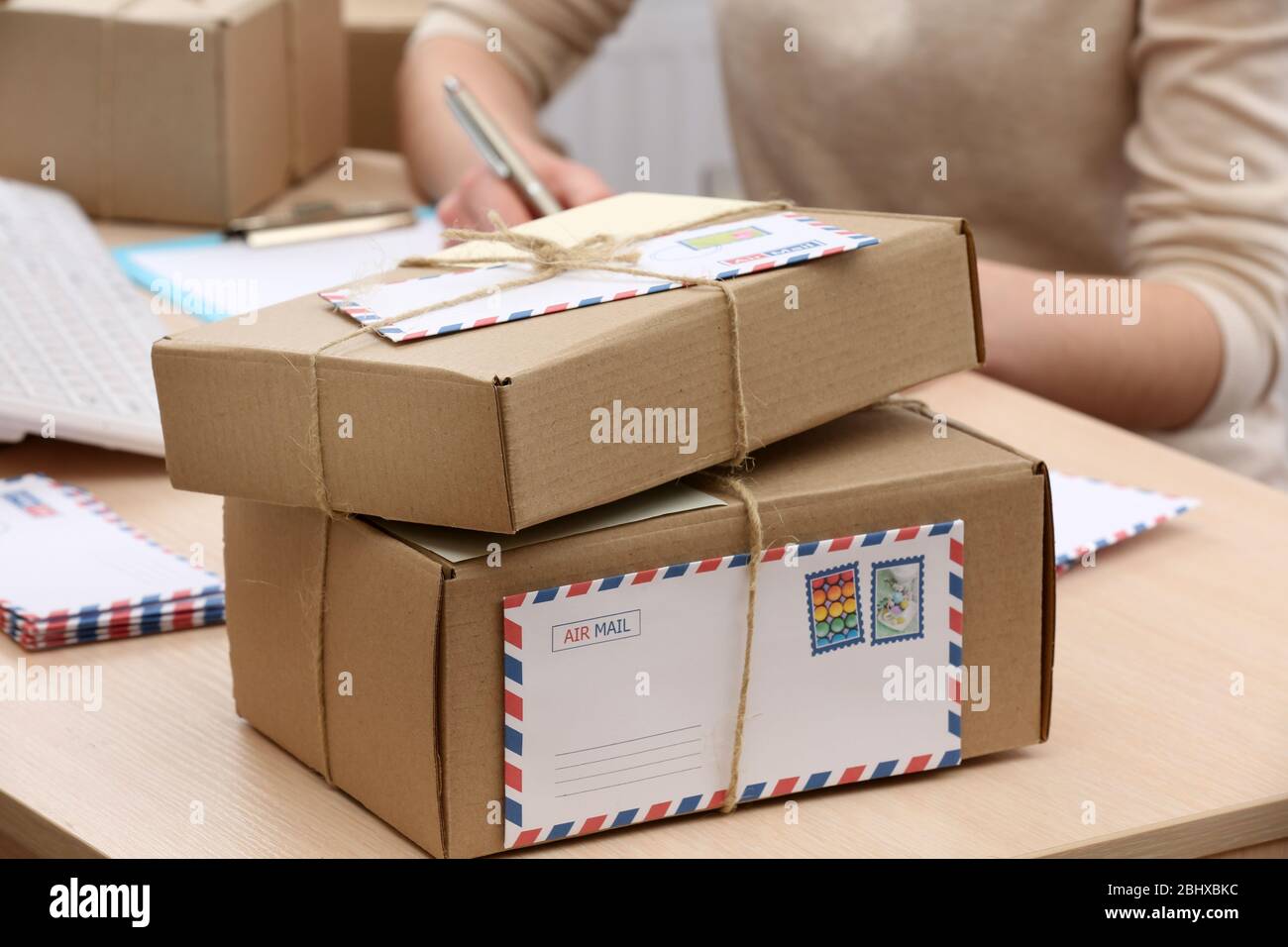 Cardboard boxes on work place in post office Stock Photo - Alamy