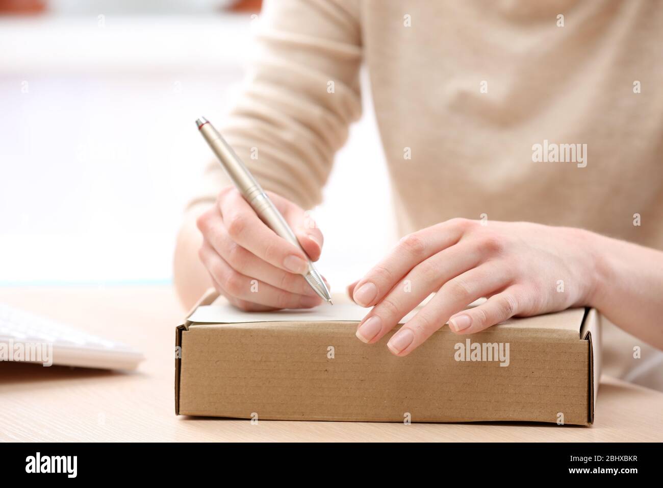Woman signs parcel in post office Stock Photo - Alamy