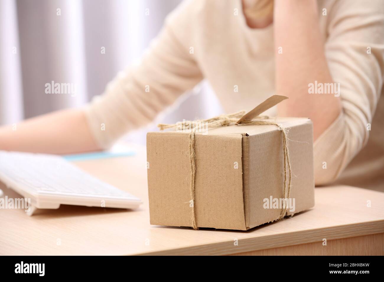 Cardboard box on work place Stock Photo - Alamy