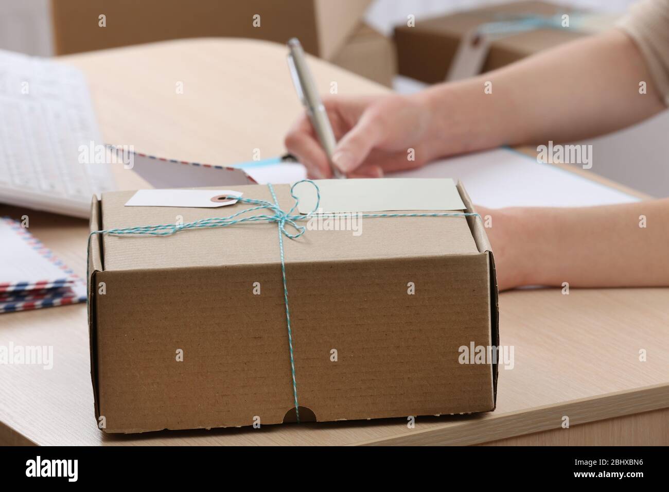 Cardboard box on work place in post office Stock Photo - Alamy
