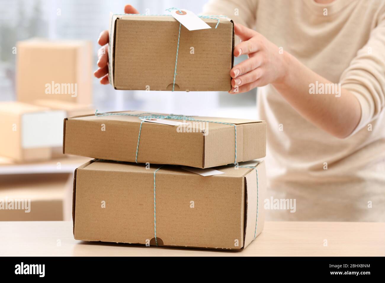 Woman gives parcel in post office Stock Photo - Alamy
