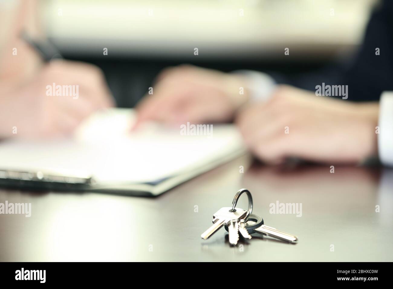 Signing of contract and keys in office Stock Photo - Alamy