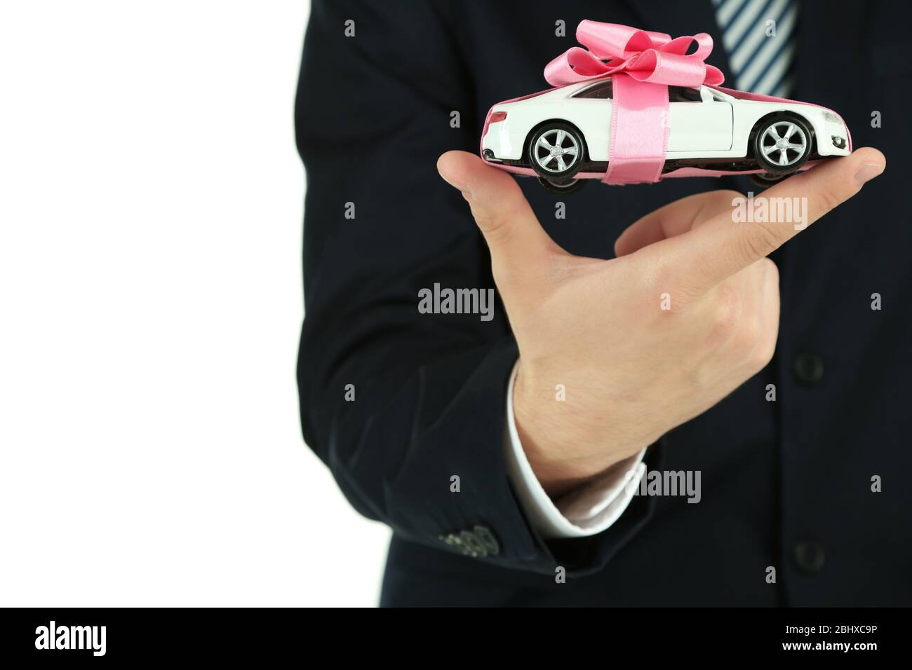Man holding model of car in his hand isolated on white Stock Photo - Alamy
